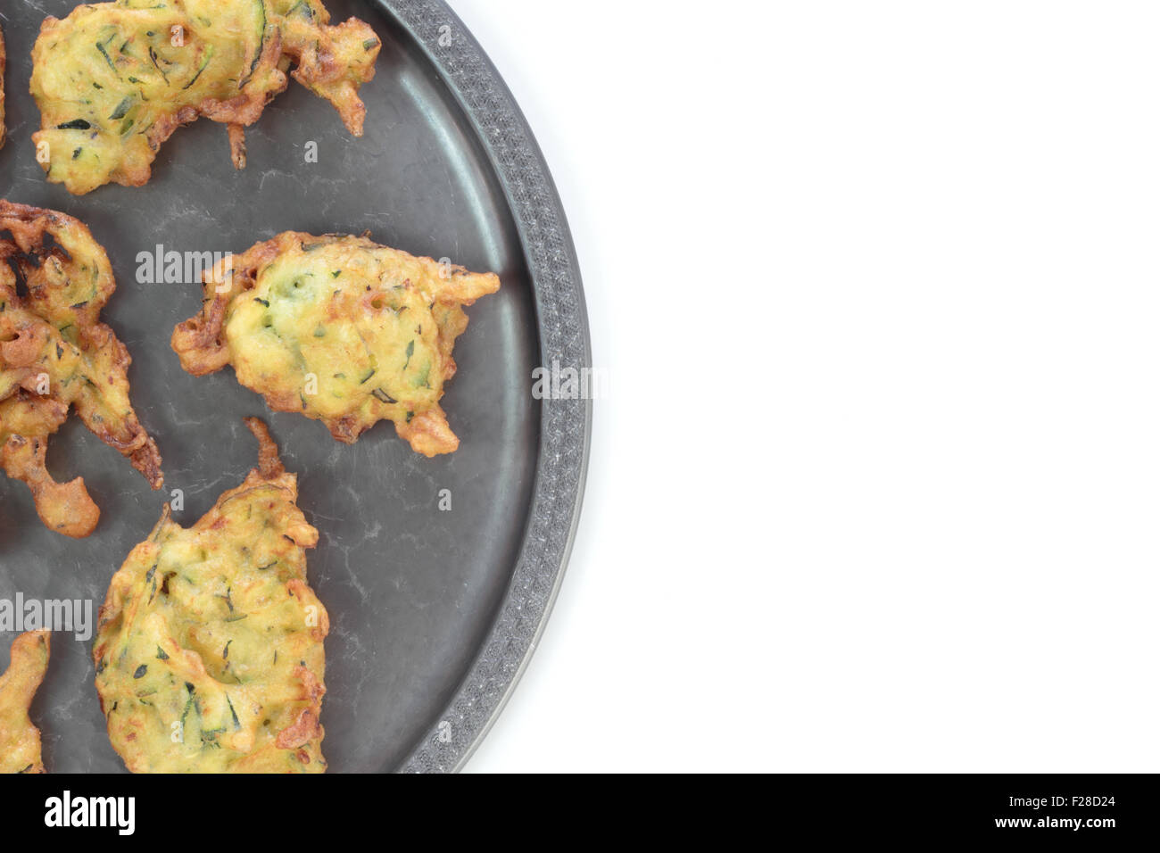 Deep fried courgette cakes, served on a tin plate Stock Photo - Alamy