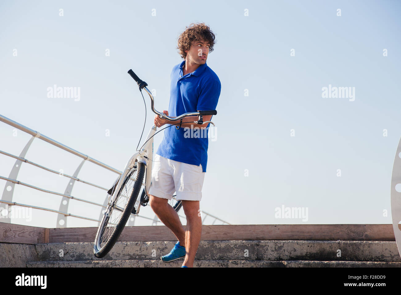 Portrait of a handsome man with bicycle outdoors Stock Photo - Alamy
