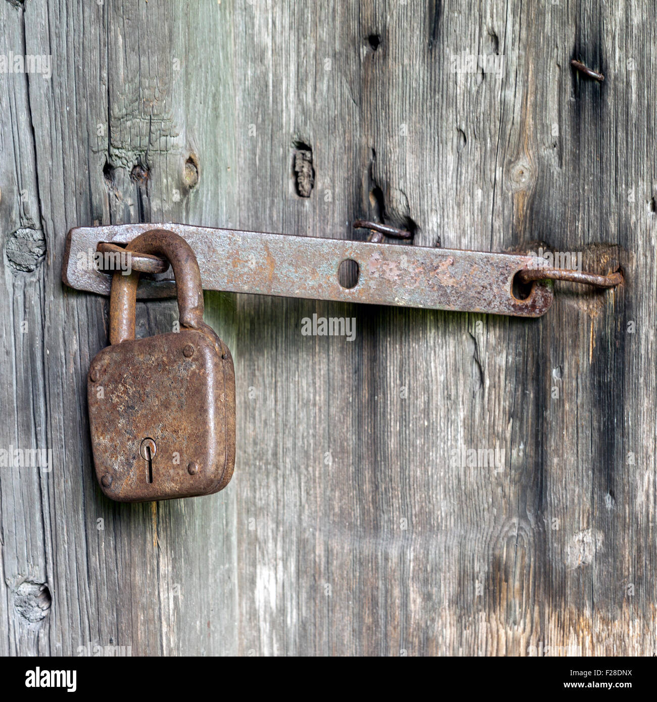 Old wooden doors locked with rusty padlock Stock Photo - Alamy