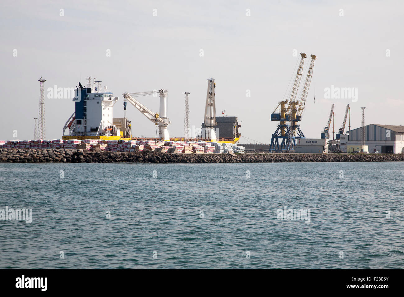 Cranes on quayside at the port of beni ansar hi-res stock photography ...
