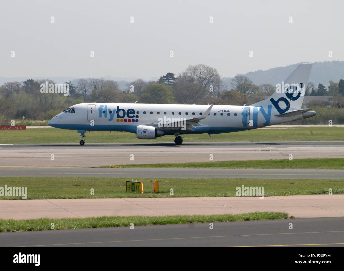 Flybe Embraer 175 taking off from Manchester Airport taxiway Stock ...