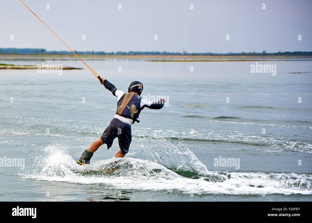 Wakeboarder shows extreme trick Stock Photo - Alamy