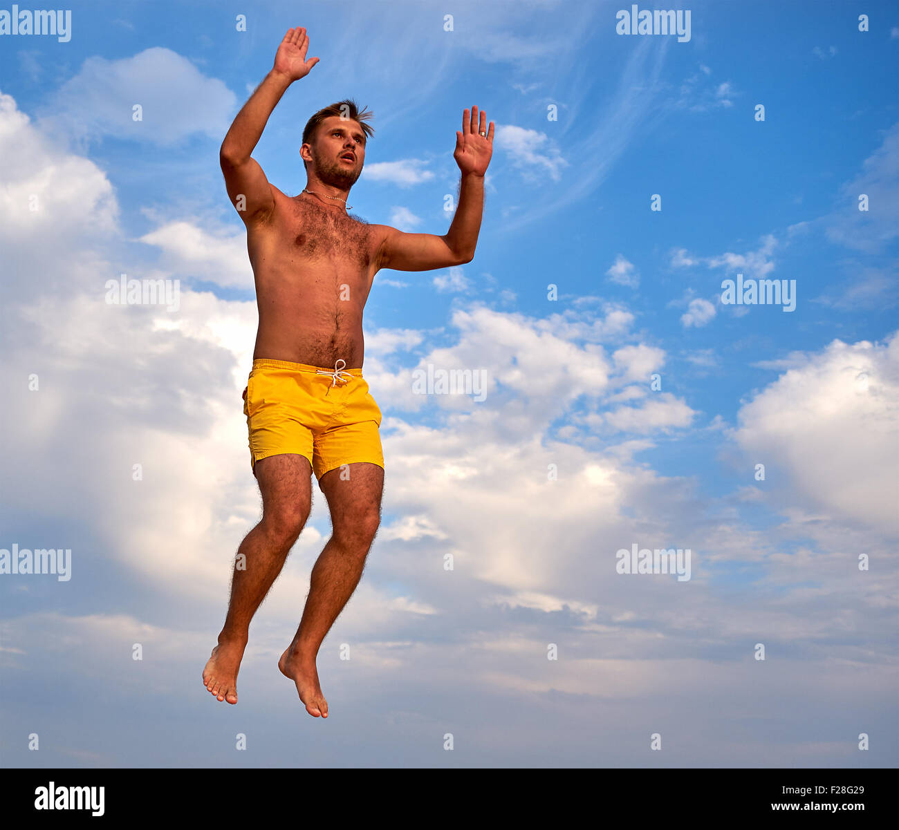 Flying man over beautiful sky Stock Photo - Alamy