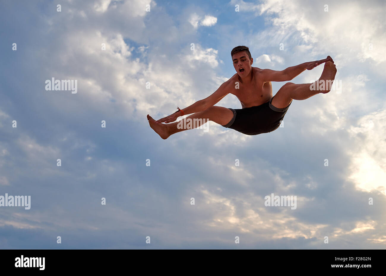 Flying man over beautiful sky Stock Photo - Alamy