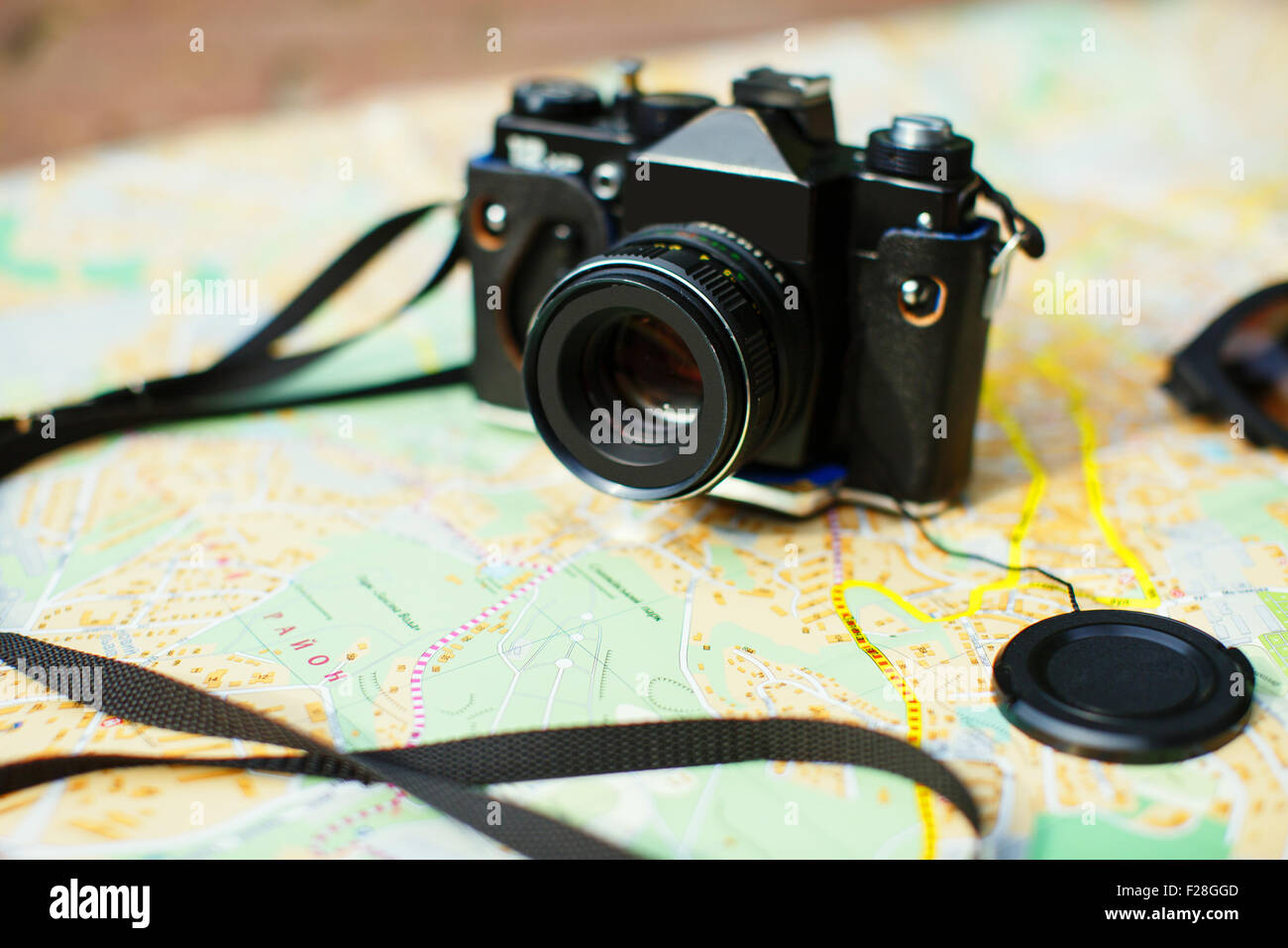 Retro camera on the tourist map, close-up Stock Photo - Alamy