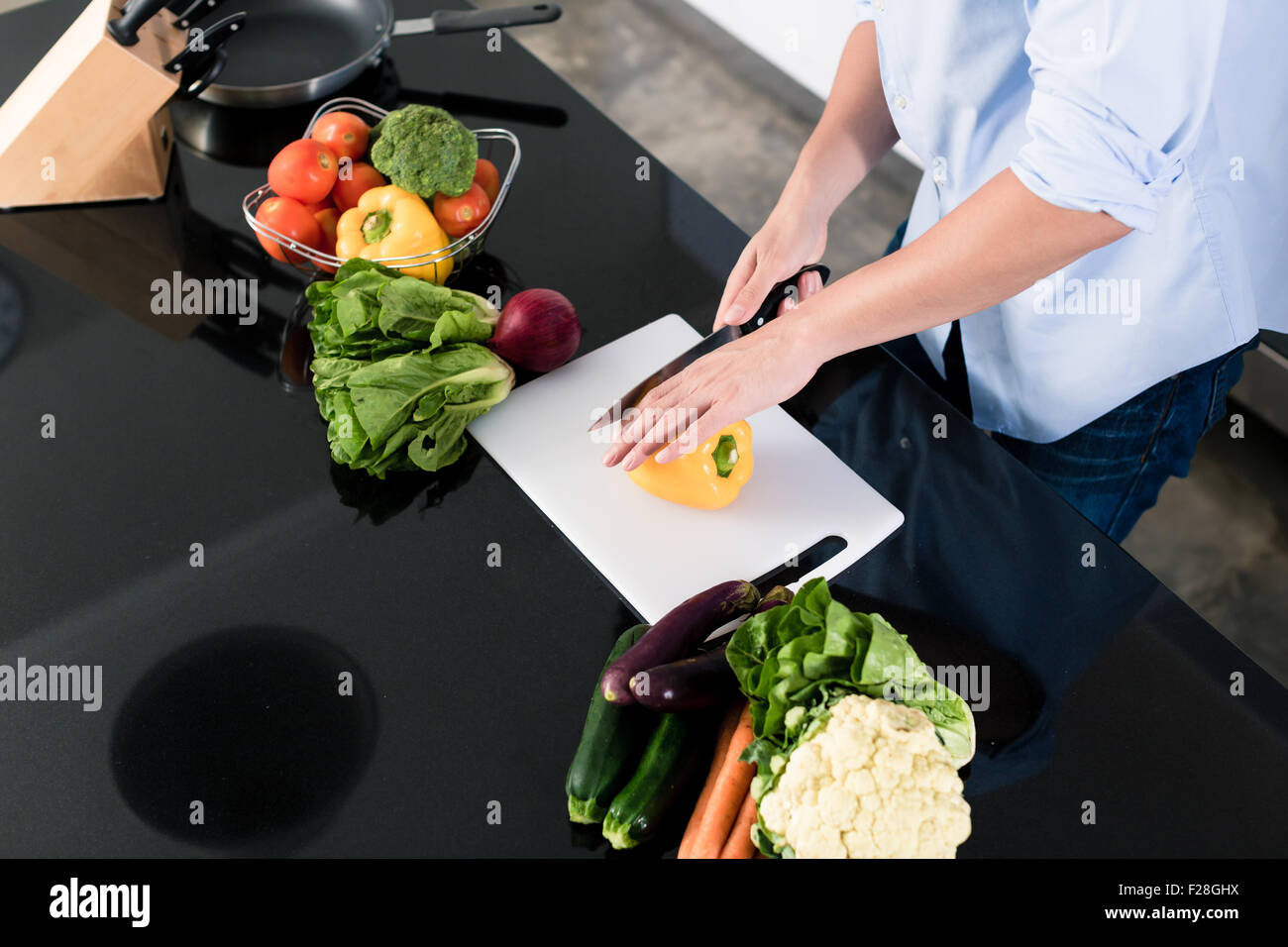 Man cutting vegetables in his kitchen Stock Photo - Alamy