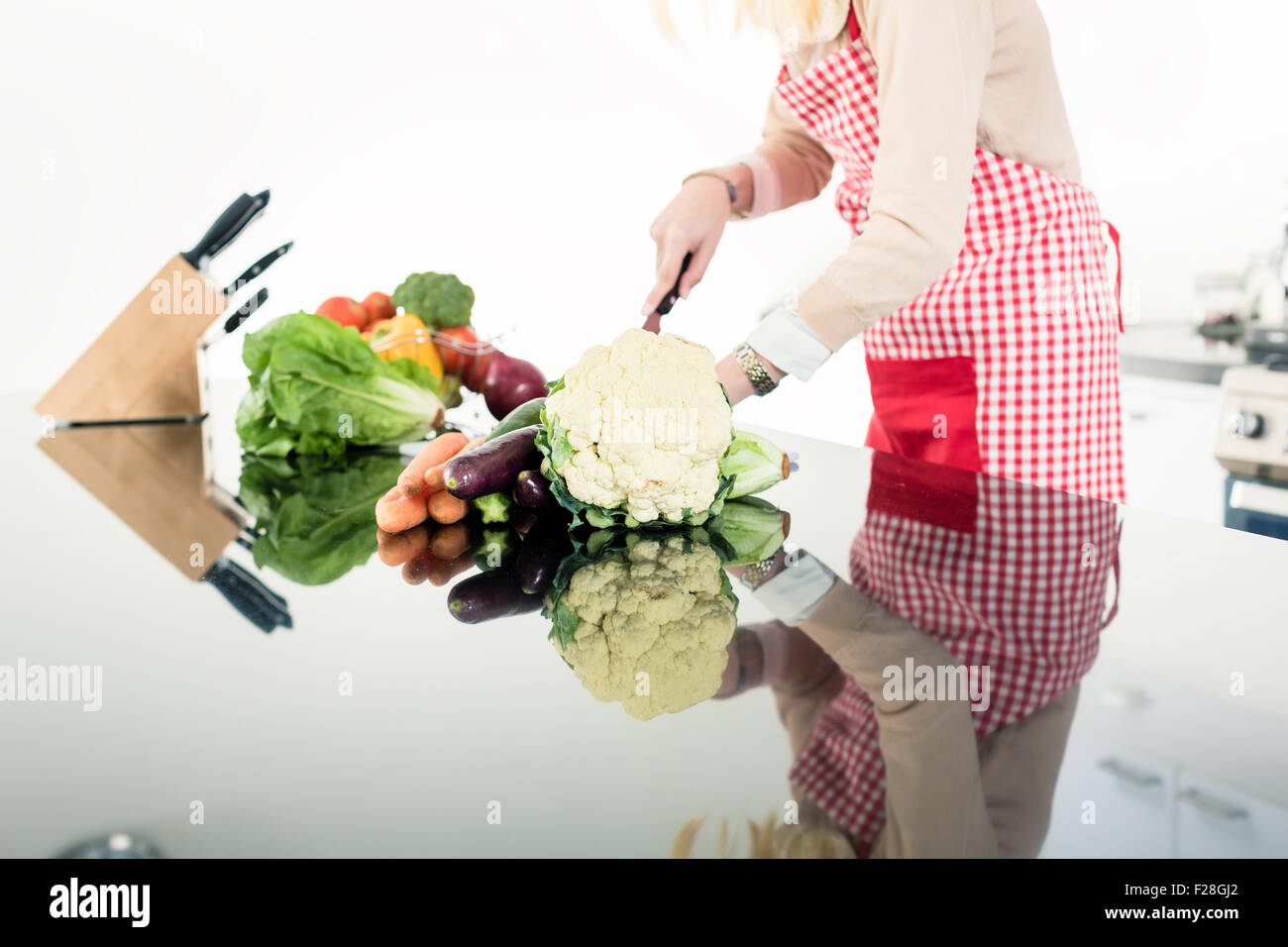 Reflection of Asian woman cooking food in very modern kitchen Stock ...