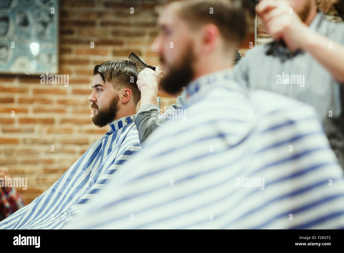 Bearded hipster in a barber shop, in the reflection in the mirror Stock ...