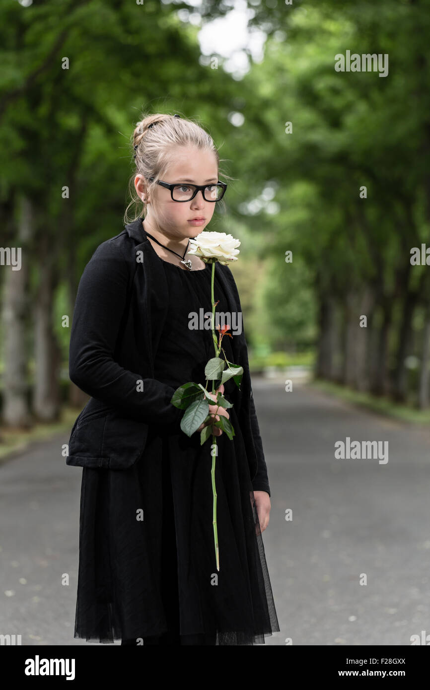 girl with white rose mourning deceased on graveyard being an orphan now ...