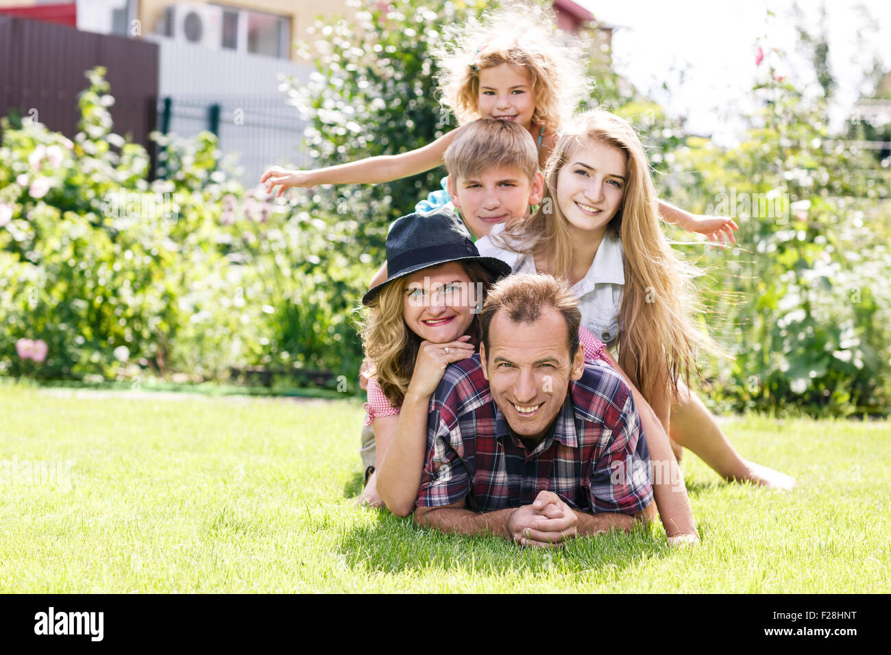 Happy family having weekend in summer park Stock Photo - Alamy