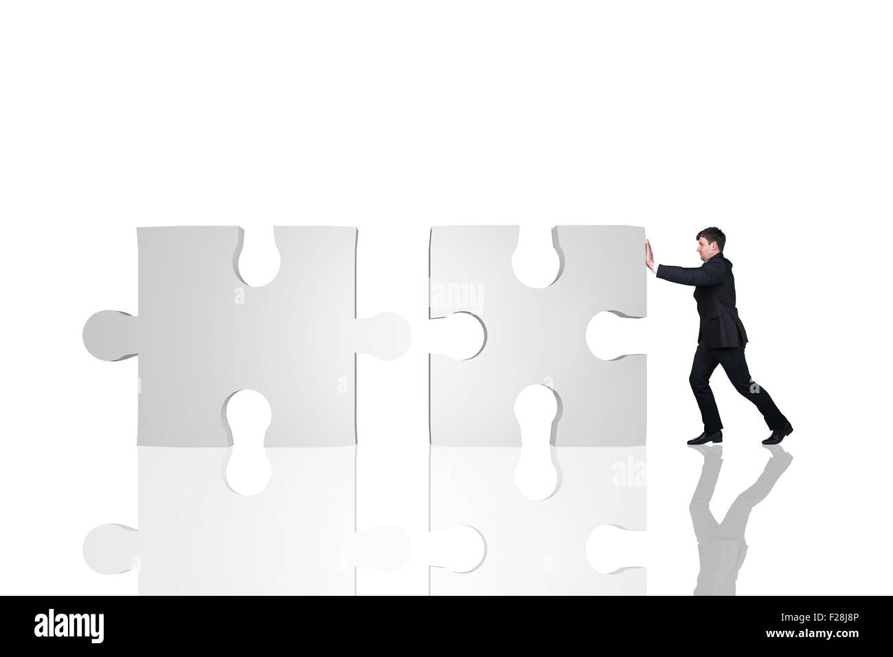 Businessman moving puzzle Stock Photo - Alamy