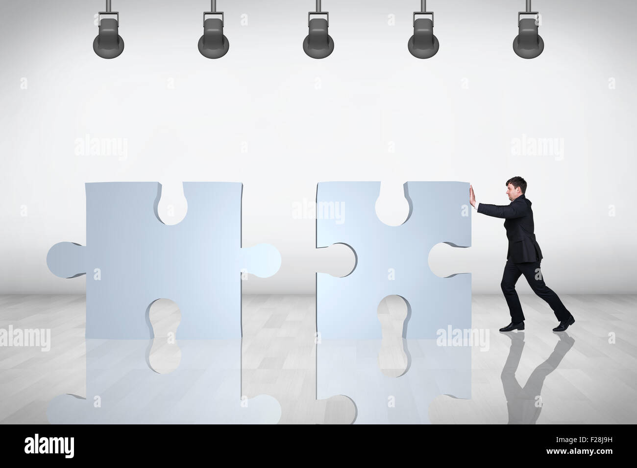 Businessman moving puzzle Stock Photo - Alamy