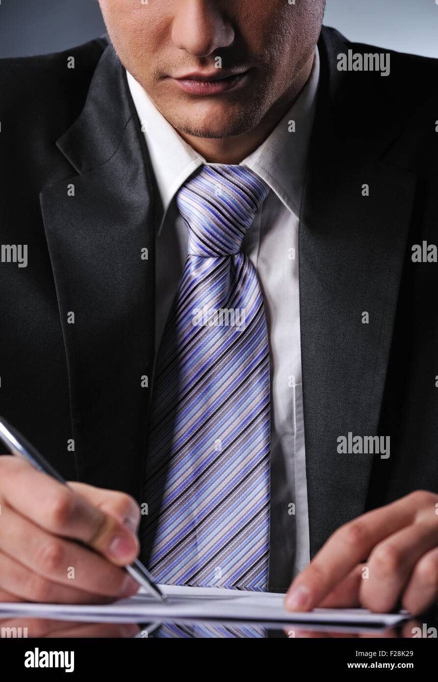 Businessman signing a contract Stock Photo - Alamy