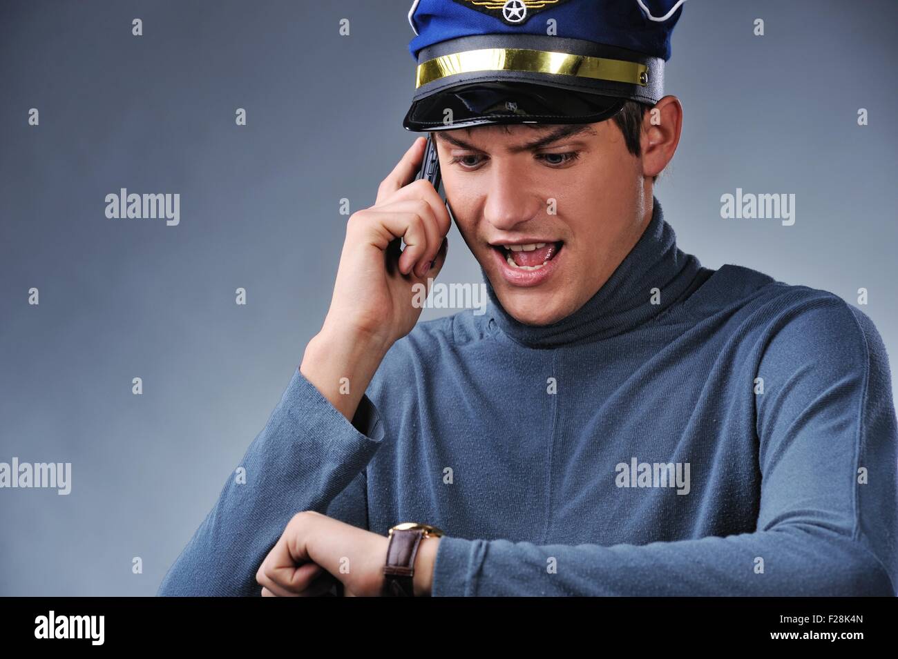Handsome pilot talking on mobile phone Stock Photo - Alamy