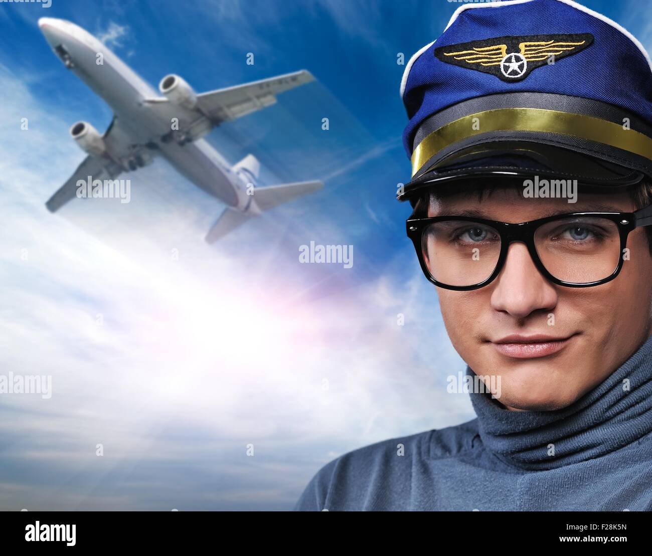 Handsome young pilot against flying plane Stock Photo - Alamy