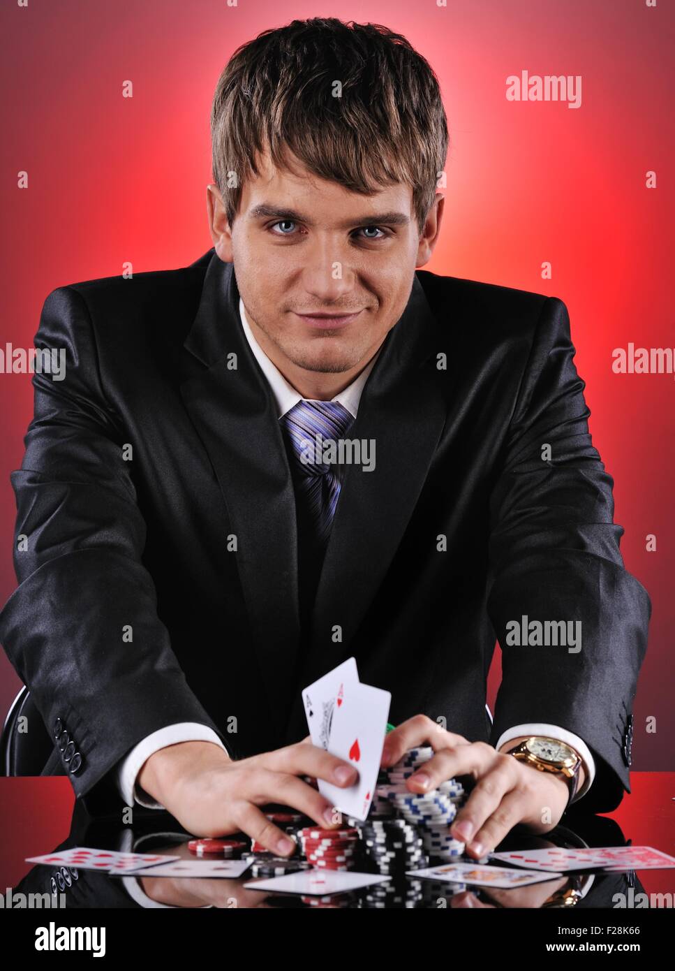 Handsome poker player with two aces in his hands Stock Photo - Alamy