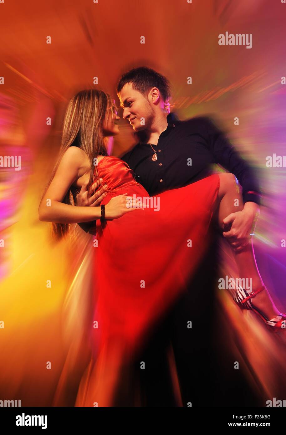 Young couple dancing in the night club Stock Photo - Alamy