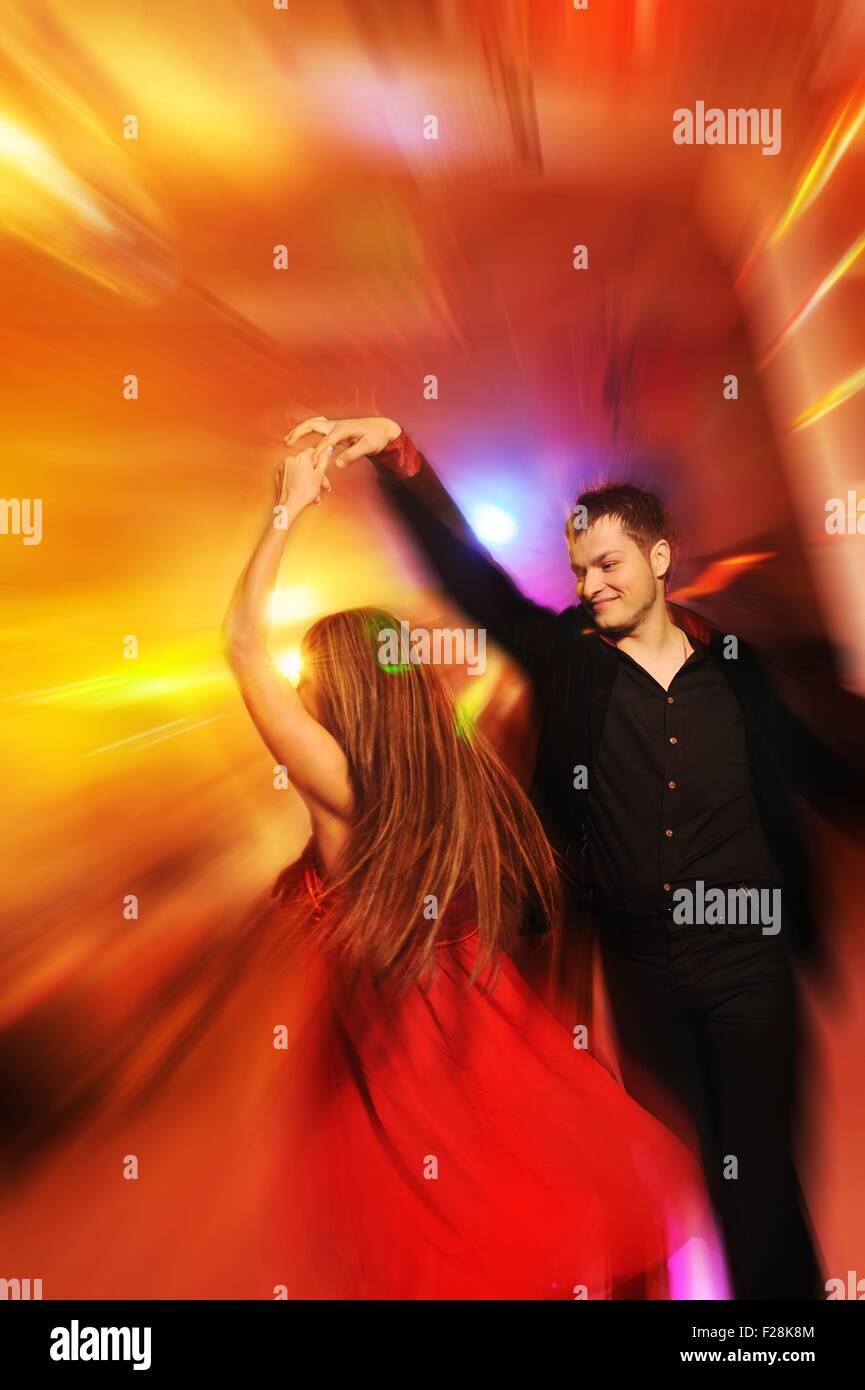 Young couple dancing in the night club Stock Photo - Alamy