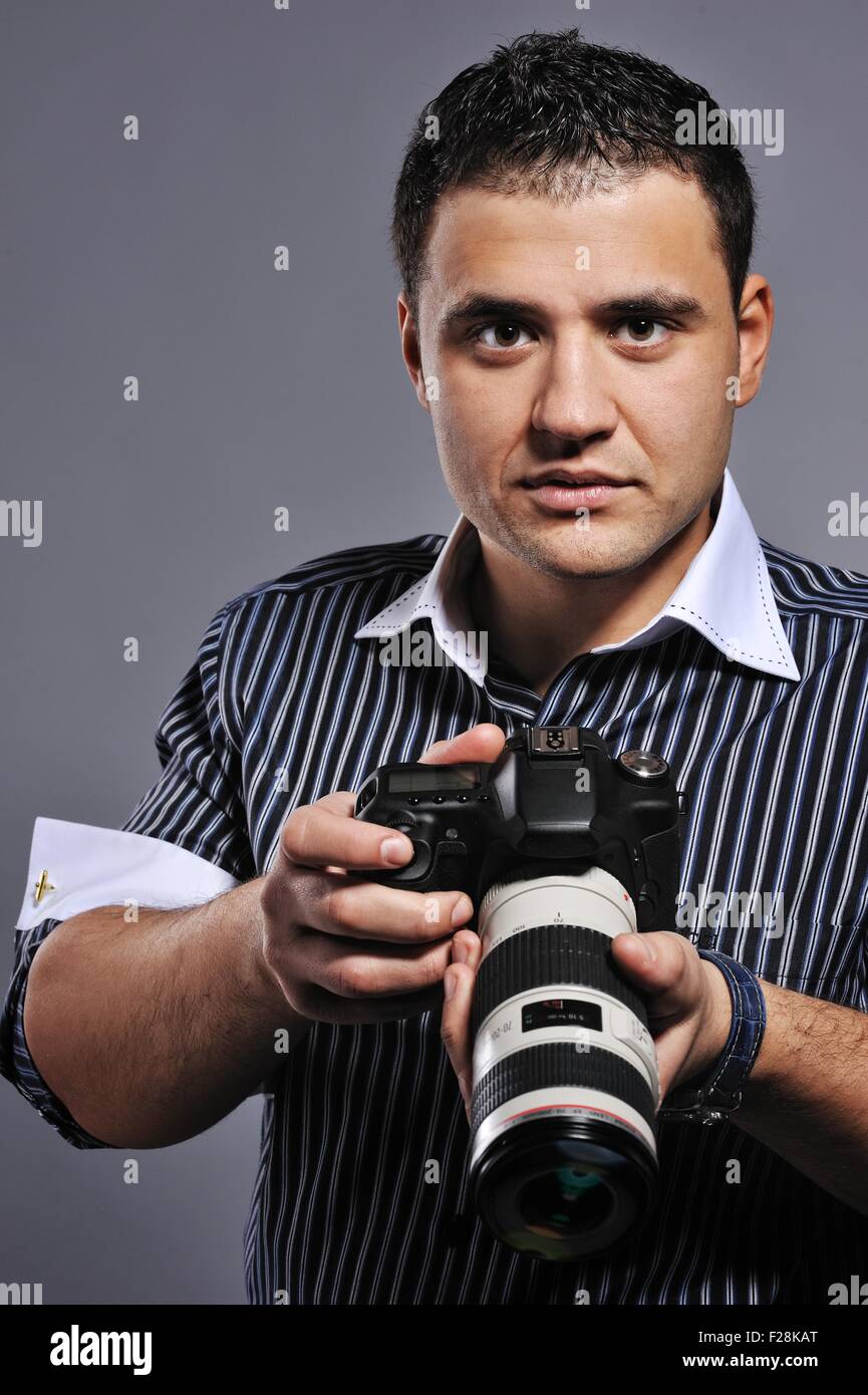 Handsome man with a photocamera Stock Photo - Alamy
