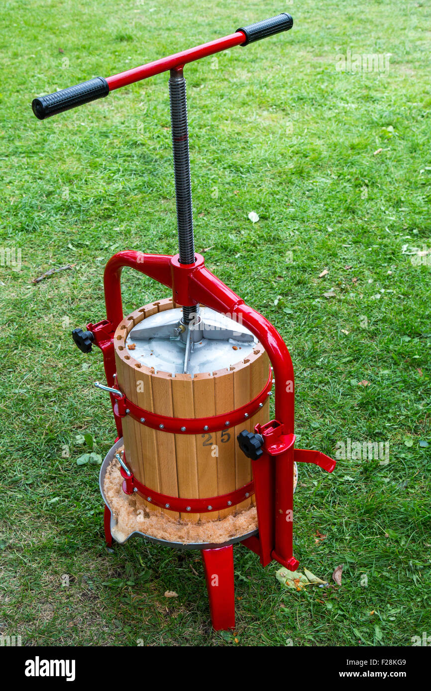 Traditional apple press made from a small wooden barrel and a metal ...