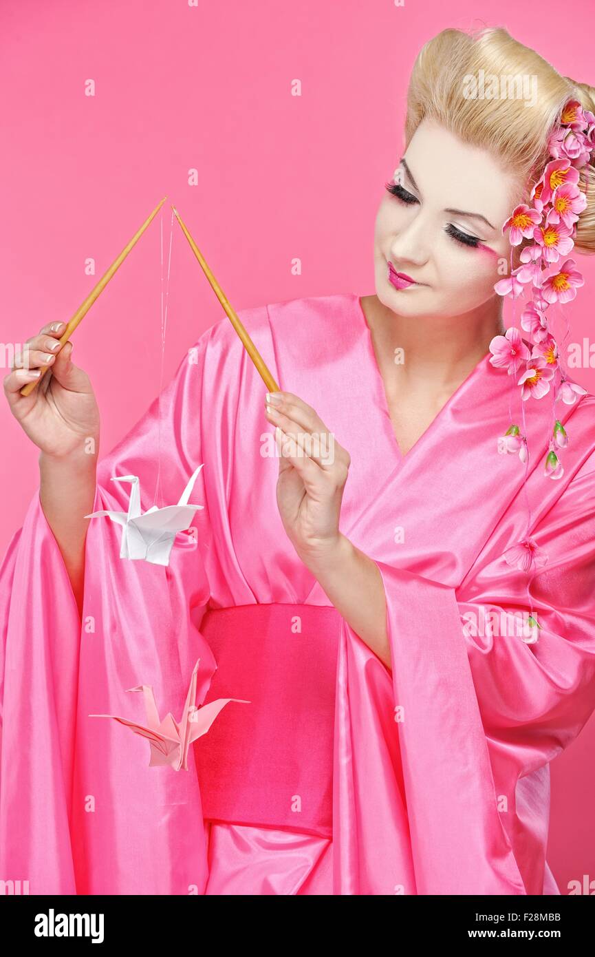 Beautiful geisha with an origami birds Stock Photo - Alamy