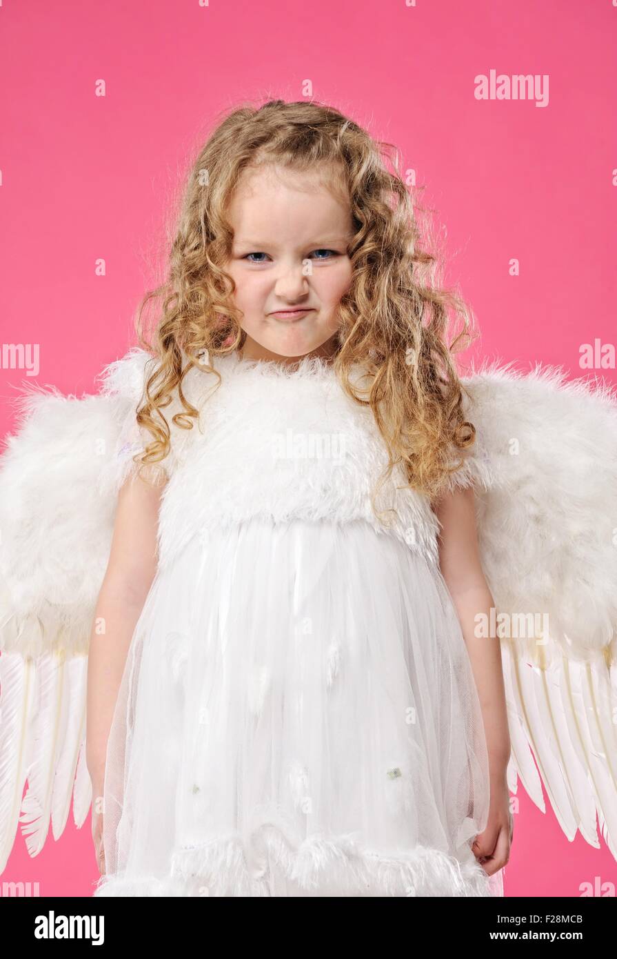 Little angel girl making funny face Stock Photo - Alamy