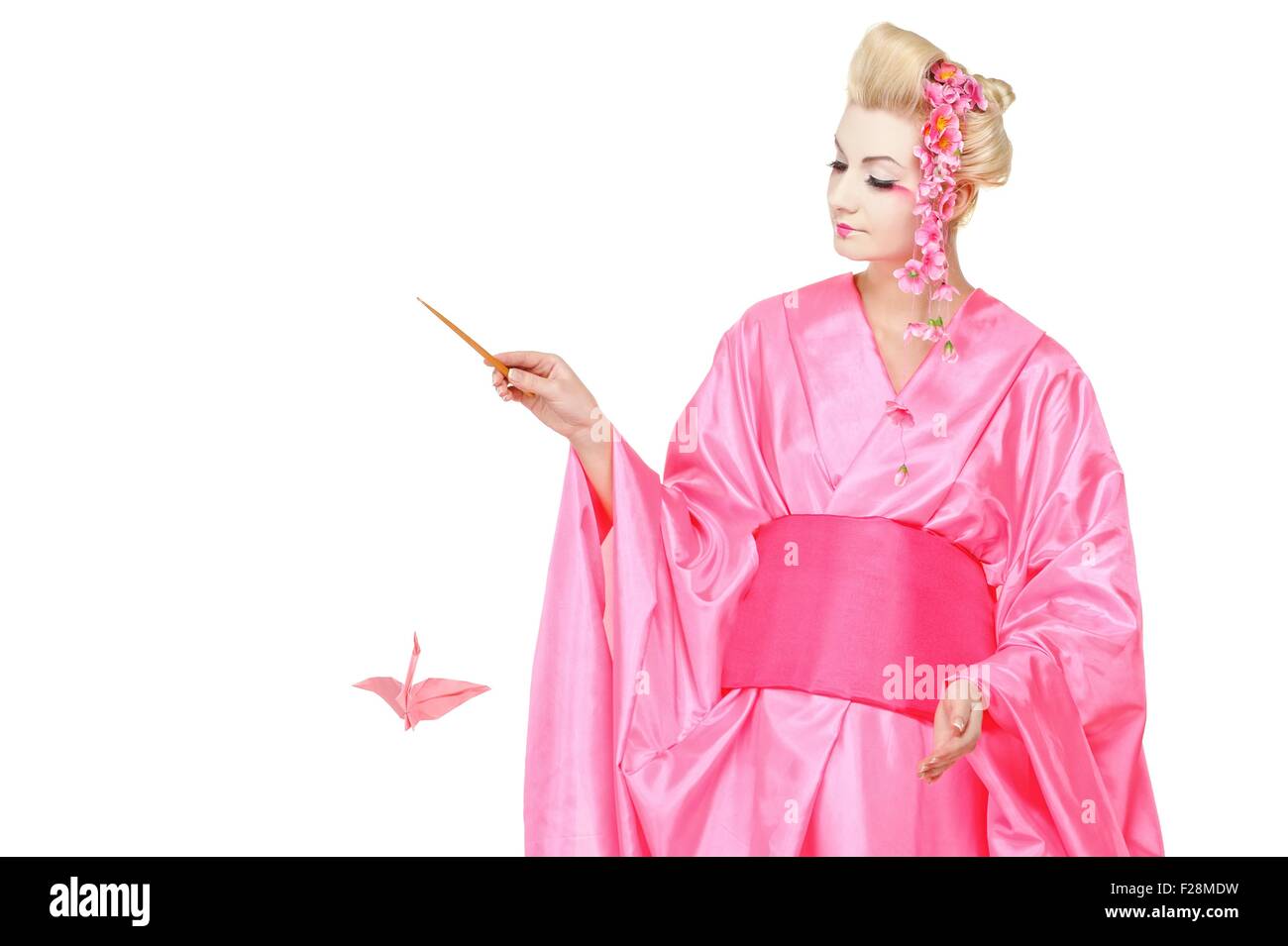 Beautiful geisha holding origami bird Stock Photo - Alamy