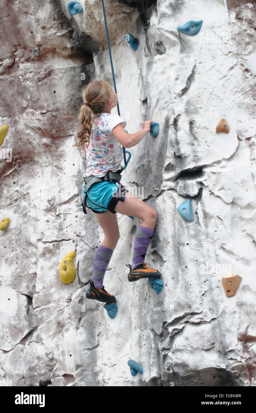 Young teen girl climbs up an artificial climbing wall Stock Photo - Alamy
