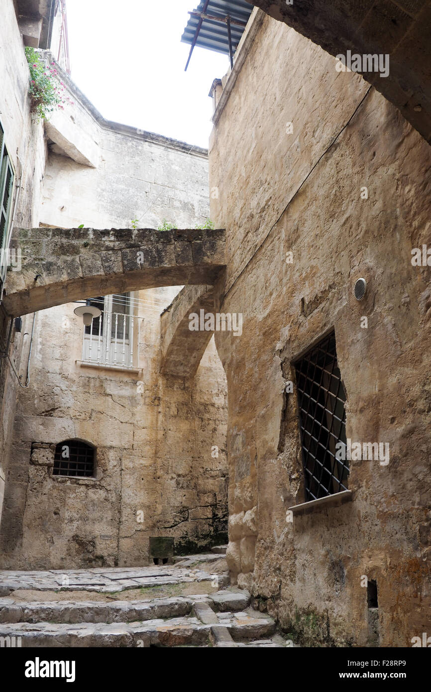 Stone steps between two stone buildings braced by stone arches Stock ...
