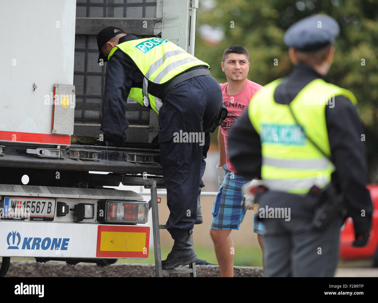 A policeman climbs a truck as the other looks on at the Czech-Austrian ...