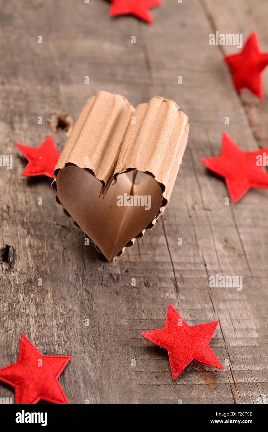 Love concept background with a heart shaped piece of cardboard on a ...