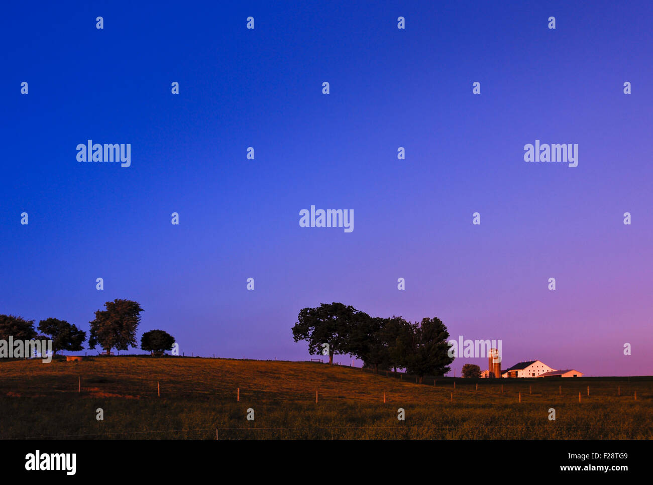 Sunlit farmhouse beneath a vivid sunset sky in Lancaster County ...