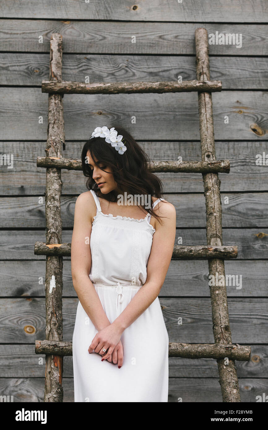 Girl climbing ladder into tree house Stock Photo - Alamy