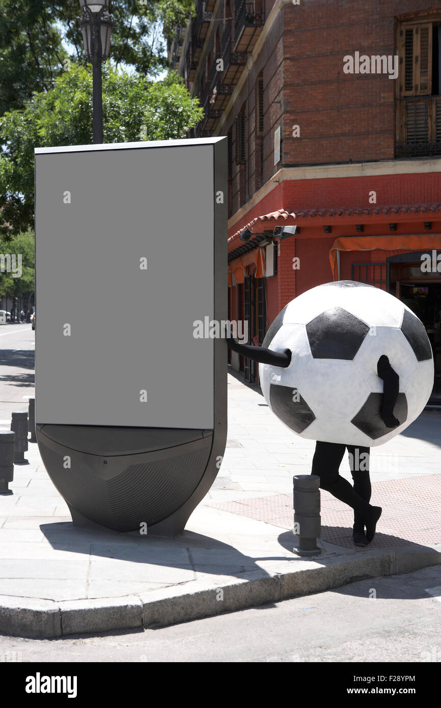 Soccer ball disguise on a street with advertising Stock Photo - Alamy