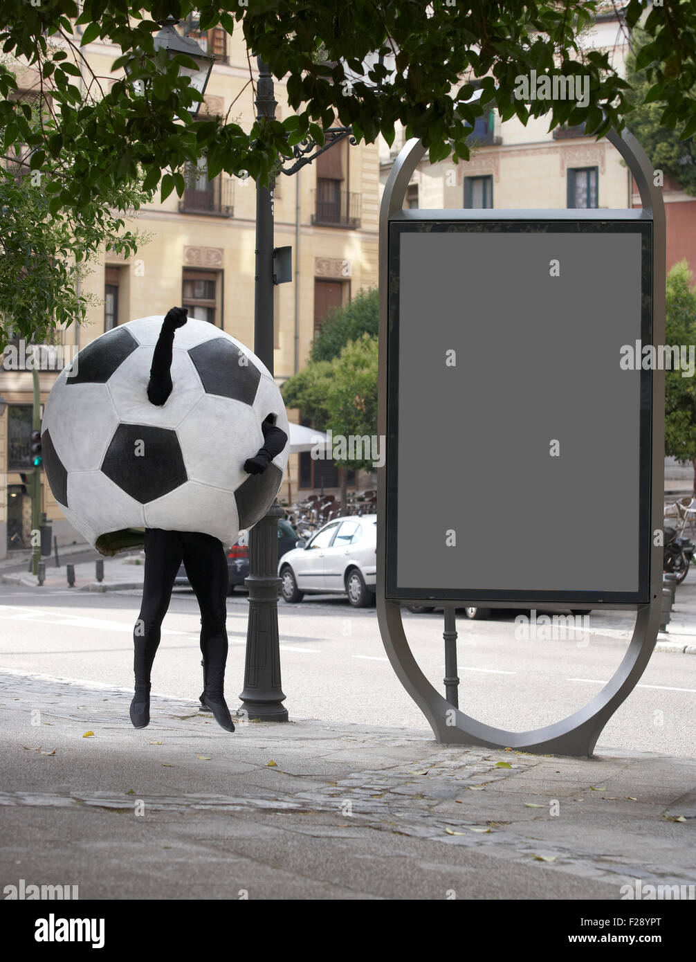 Soccer ball disguise on a street with victory sign Stock Photo - Alamy