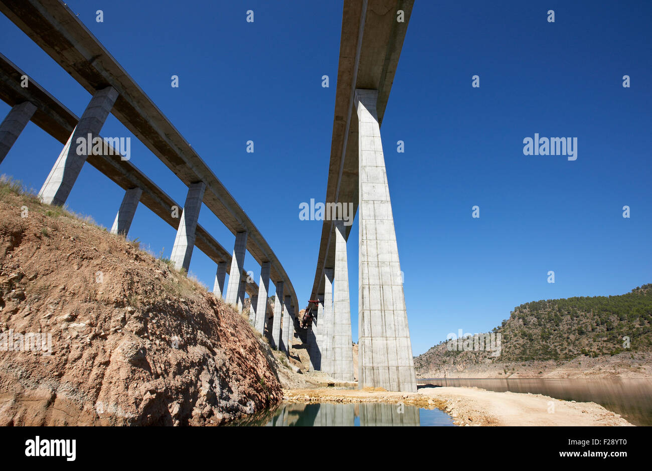 Railway and highway bridges on a landscape blue sky and lake Stock ...