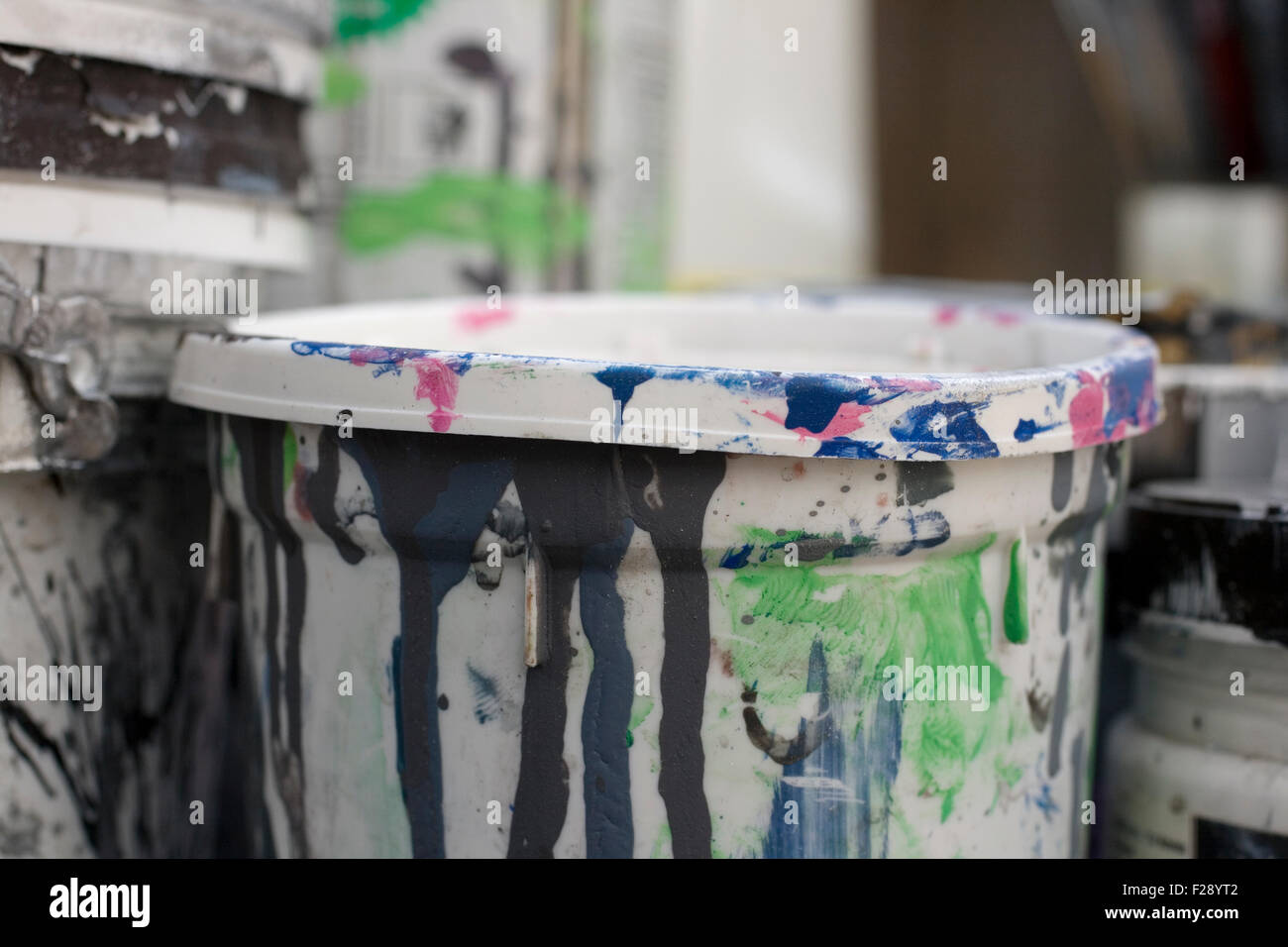 Photo of dirty plastic containers of paint Stock Photo - Alamy