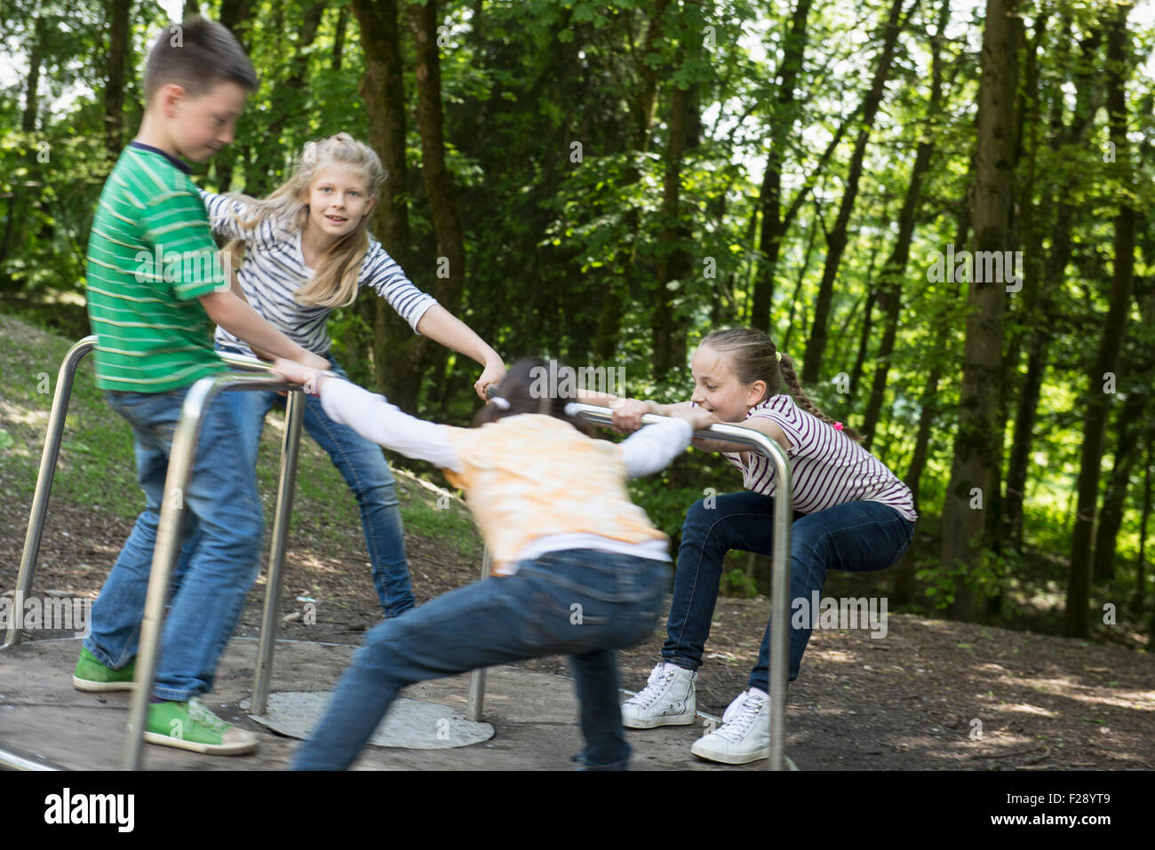 Children having fun on a carousel in playground, Munich, Bavaria ...