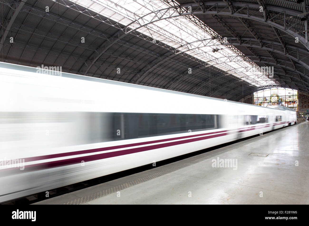 Railway station with train in movement horizontal Stock Photo - Alamy