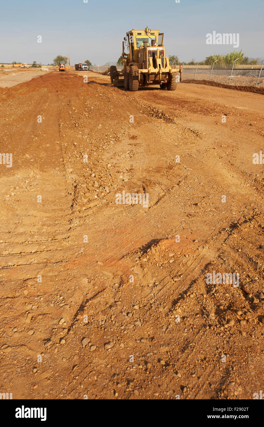 Excavator unloading sand at eathmoving works in construction site Stock ...