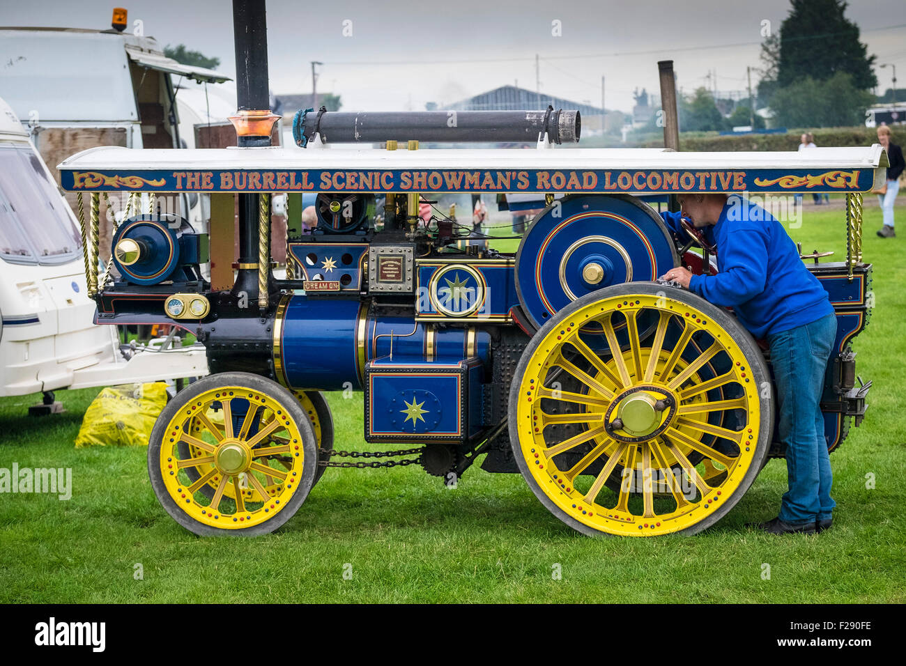 A man carrying out maintenance on his miniature steam engine at the ...