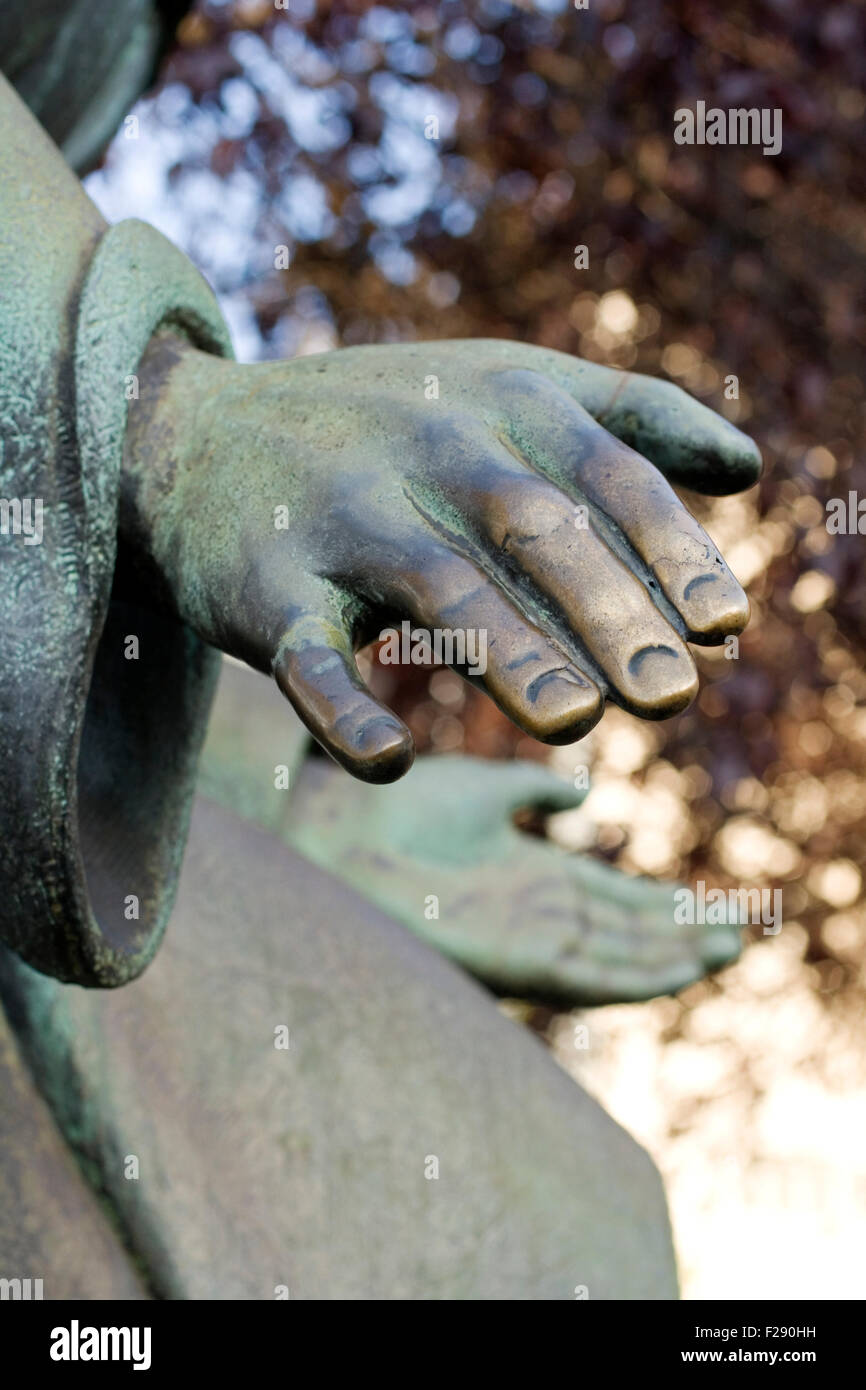 Hand of a bronze statue, Milan Stock Photo - Alamy