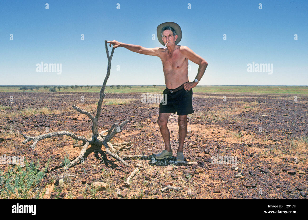 An Australian man standing in the barren desert of the Australian ...