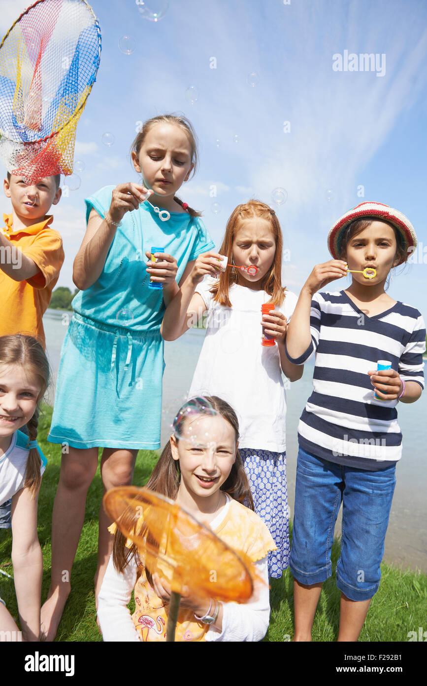 Children blowing bubbles bubble wands hi-res stock photography and ...