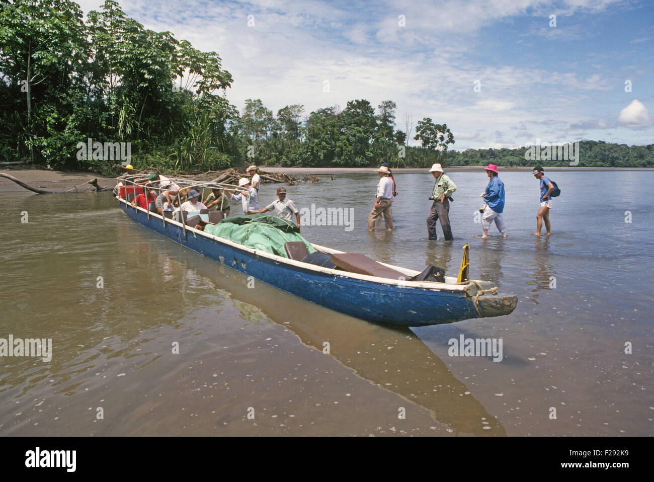 American tourists and an Ecuadorian guide exploring a tributary of the ...