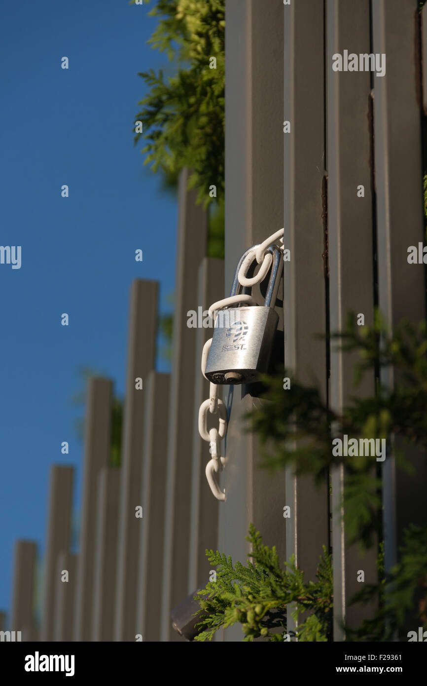 Lock and chain on metal fence Stock Photo - Alamy