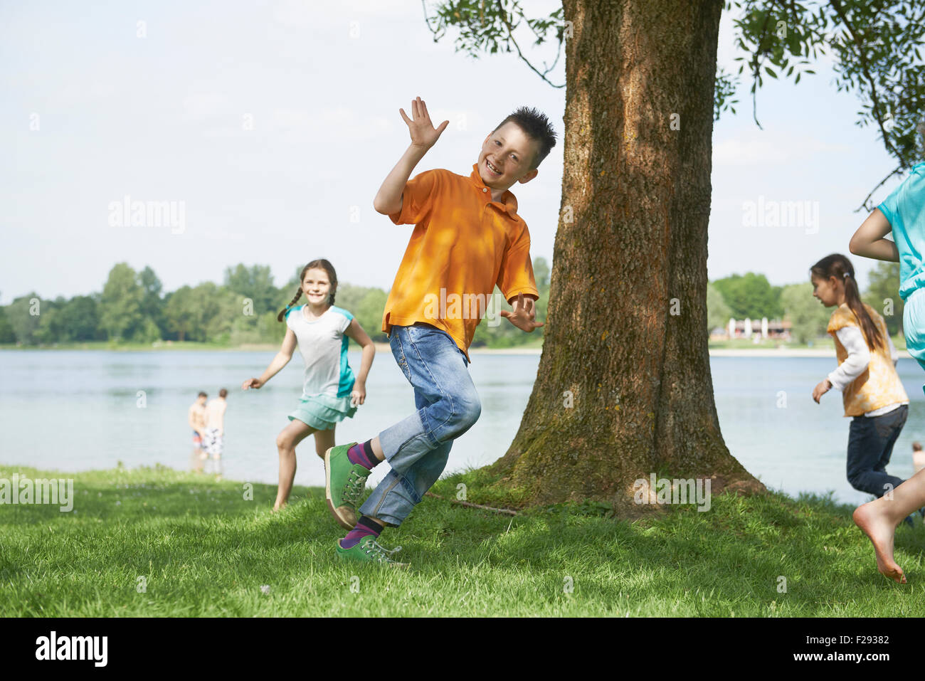 Three girls playing on tree hi-res stock photography and images - Alamy
