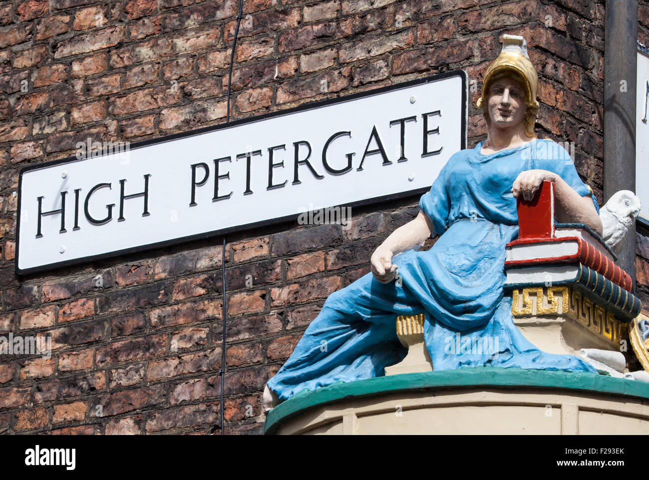 The street sign for High Petergate in York with a statue of Minerva ...