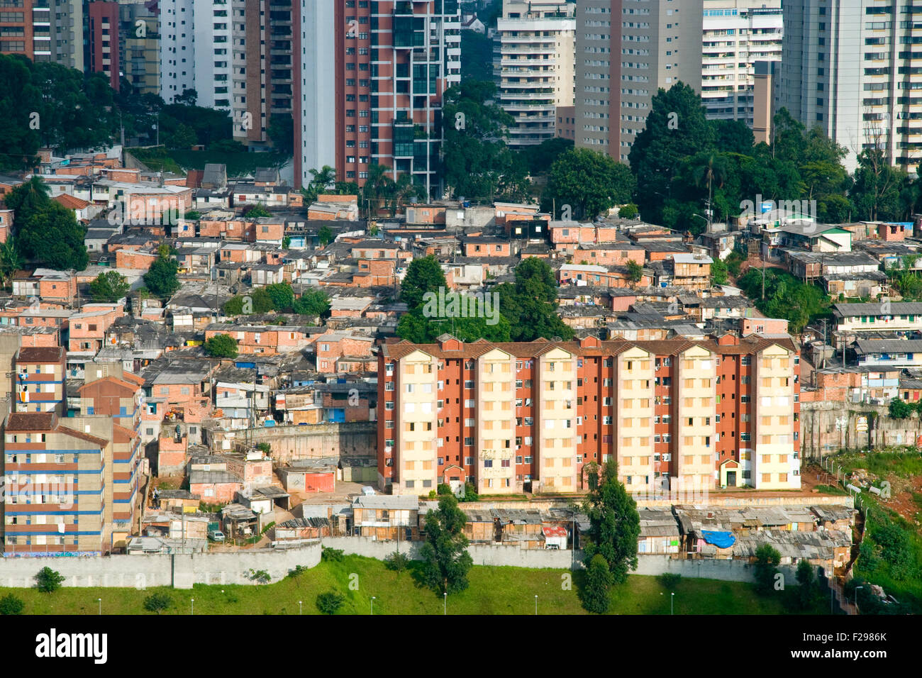 Scenic view of shanty town contrasting with skyscrapers in background ...
