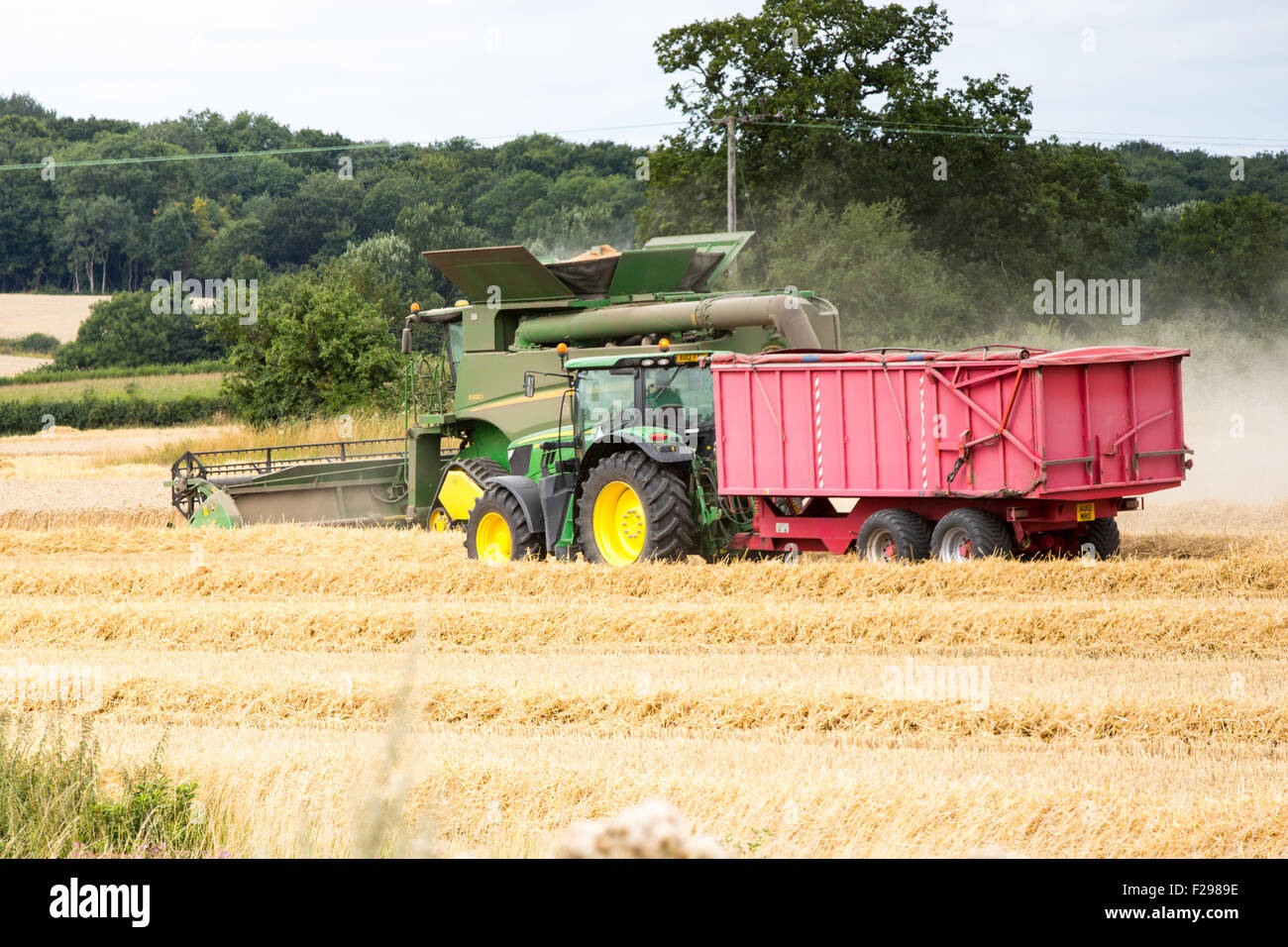 Combine harvester / tractor at work harvesting wheat Stock Photo - Alamy